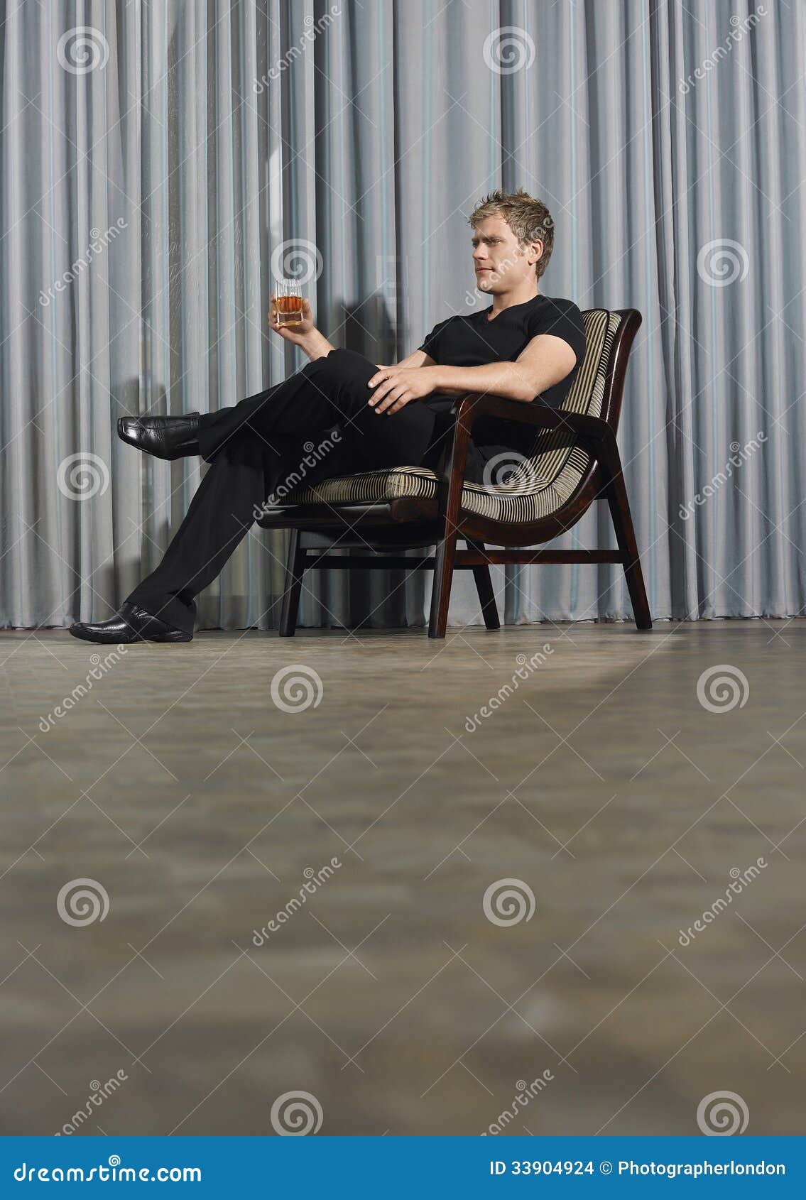 Man with Drink Sitting on Chair Stock Photo - Image of copyspace, adult ...