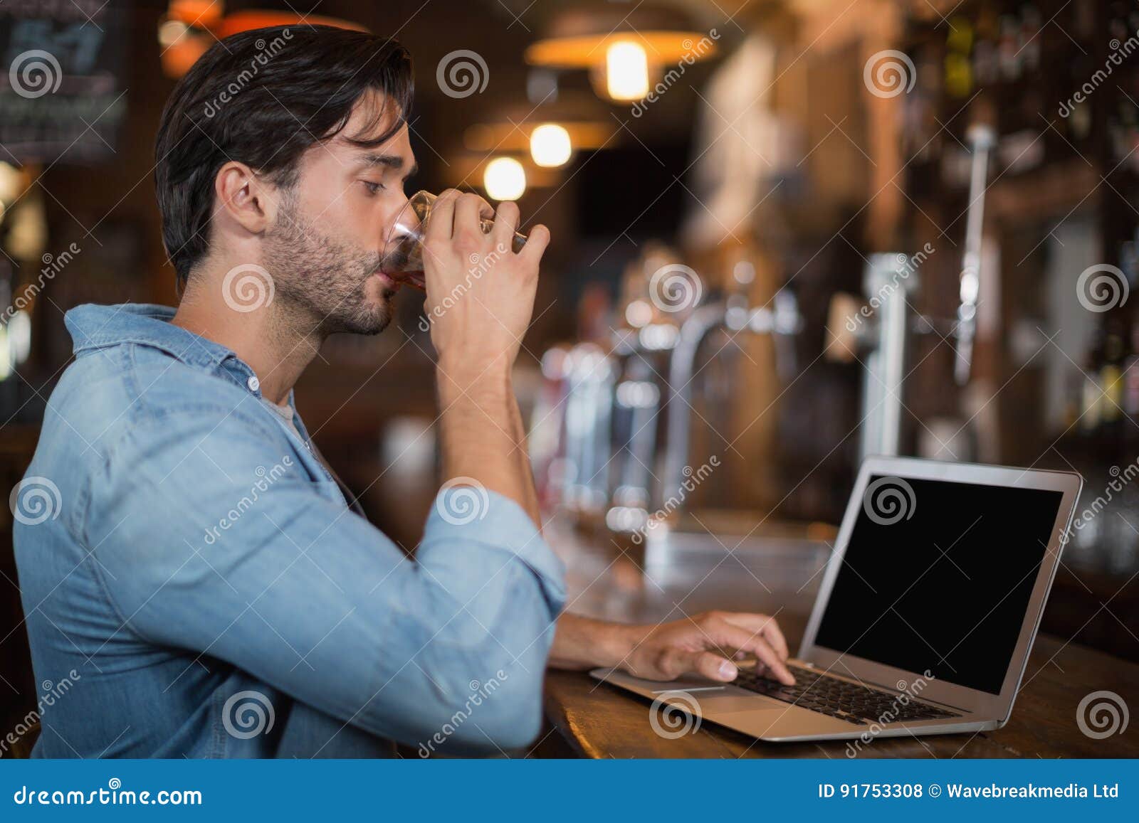 Man Drinking Beer while Using Laptop in Restarant Stock Photo - Image ...