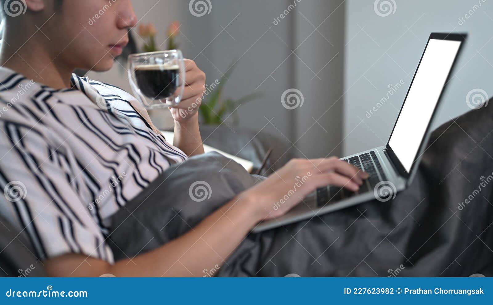 Man Drinking Coffee and Using Computer Laptop on a Bed. Stock Photo ...