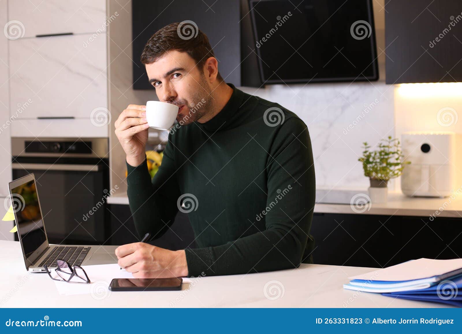 Man Drinking a Cup of Coffee while Working from Home Stock Image ...