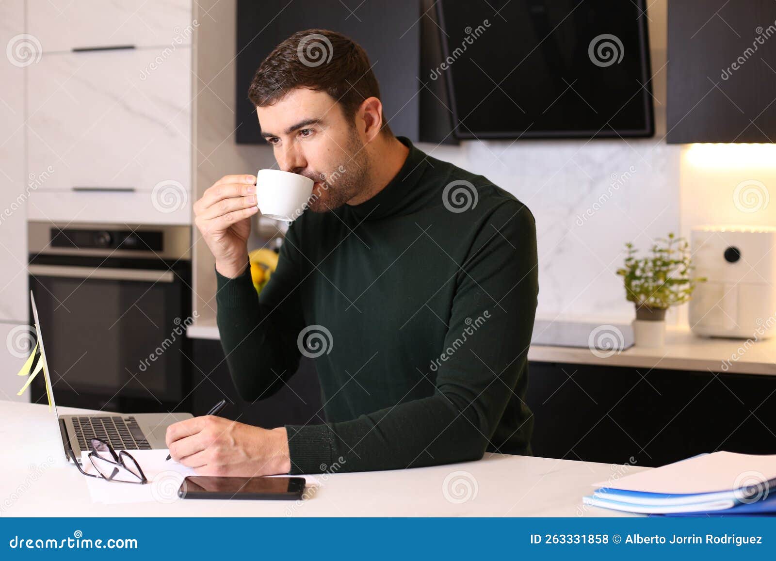 Man Drinking a Cup of Coffee while Working from Home Stock Photo ...