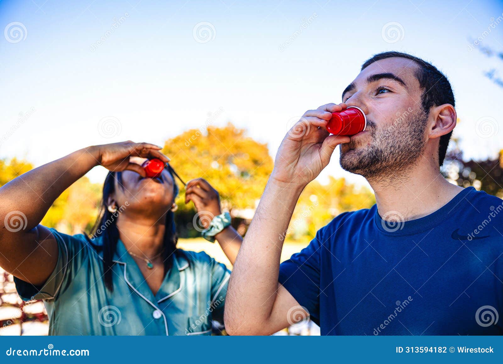 Drinking from Cup while Gazing at Woman Above Editorial Photography ...