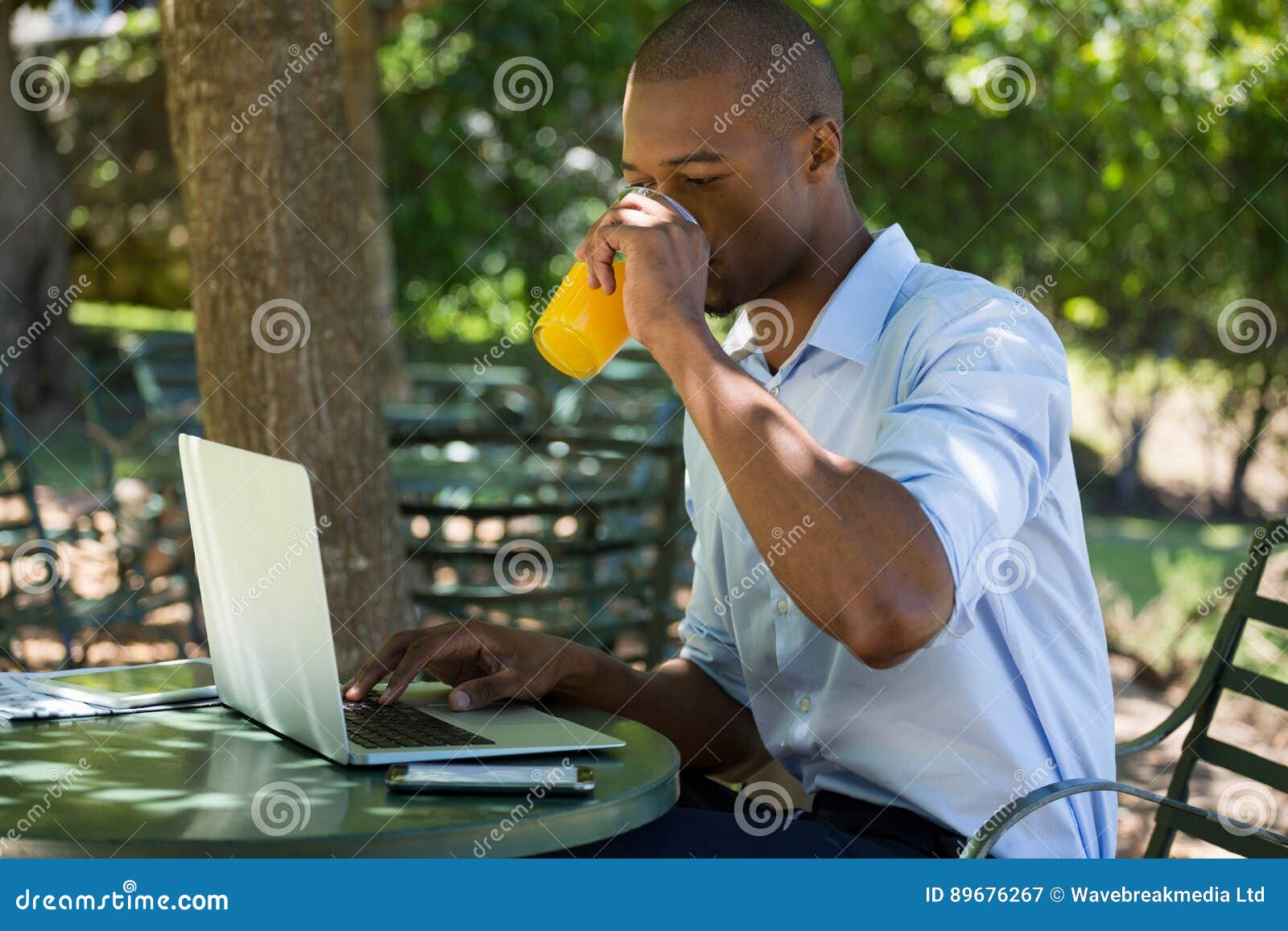 Man Drinking Juice while Using Laptop at Restaurant Stock Image - Image ...