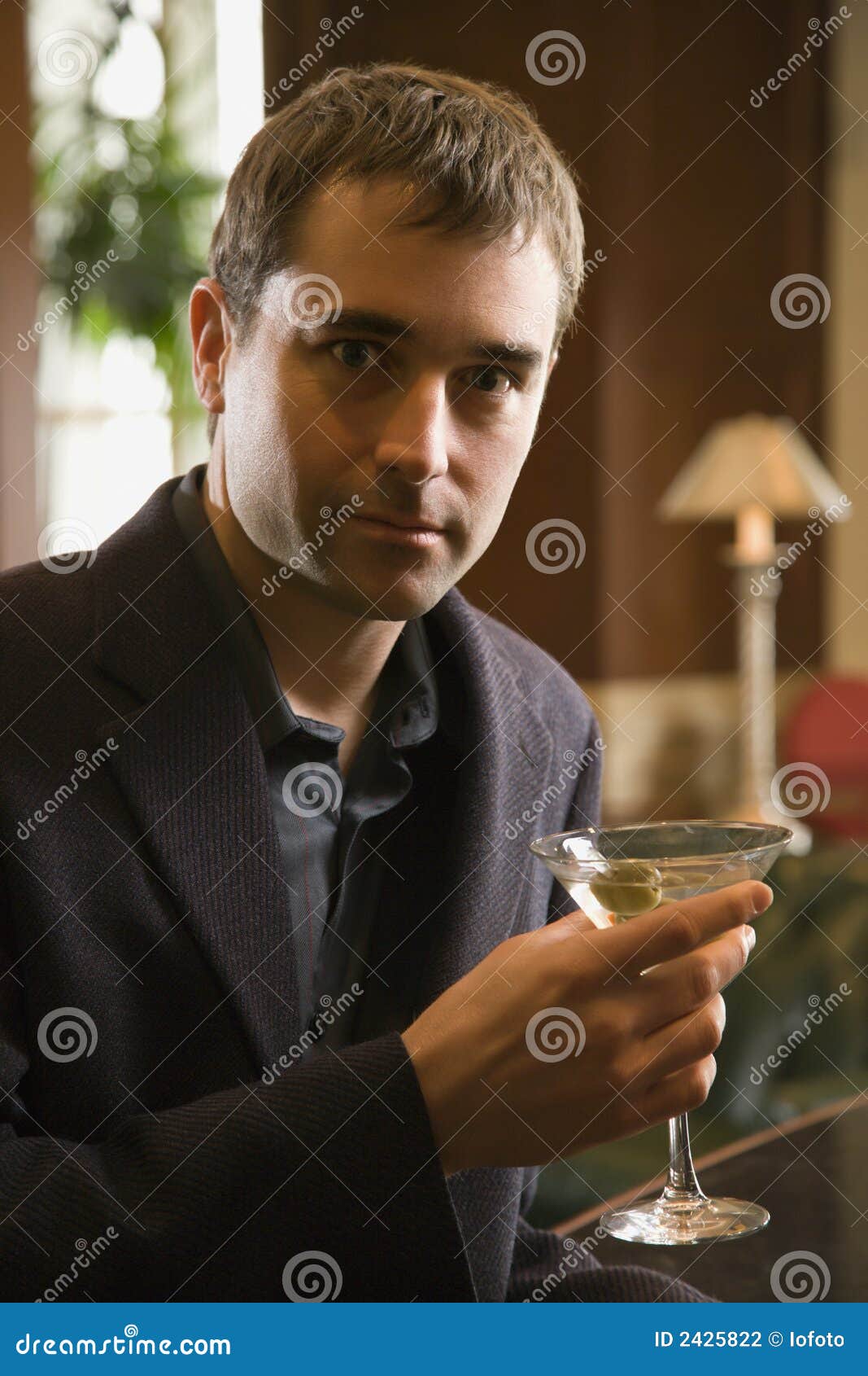 Man drinking martini. stock photo. Image of holding, night - 2425822
