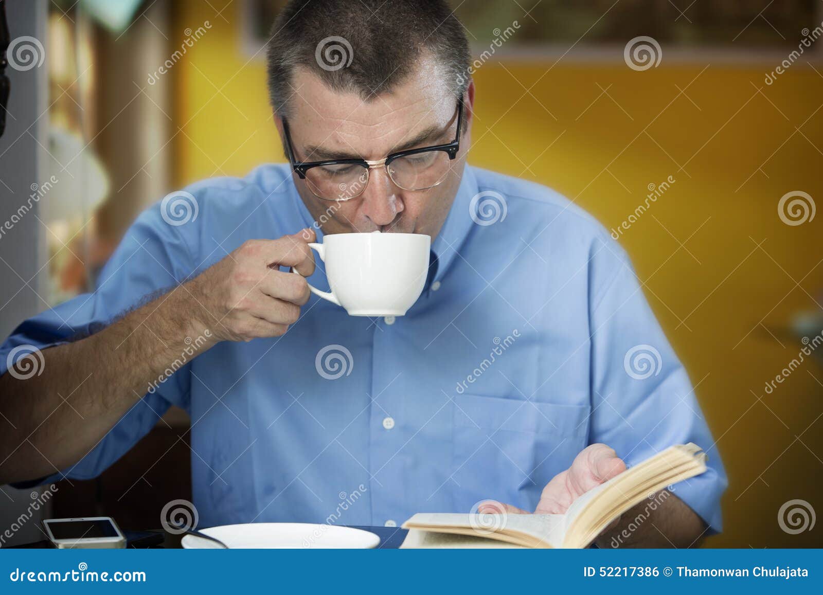 Man Drinking and Reading stock photo. Image of learning - 52217386