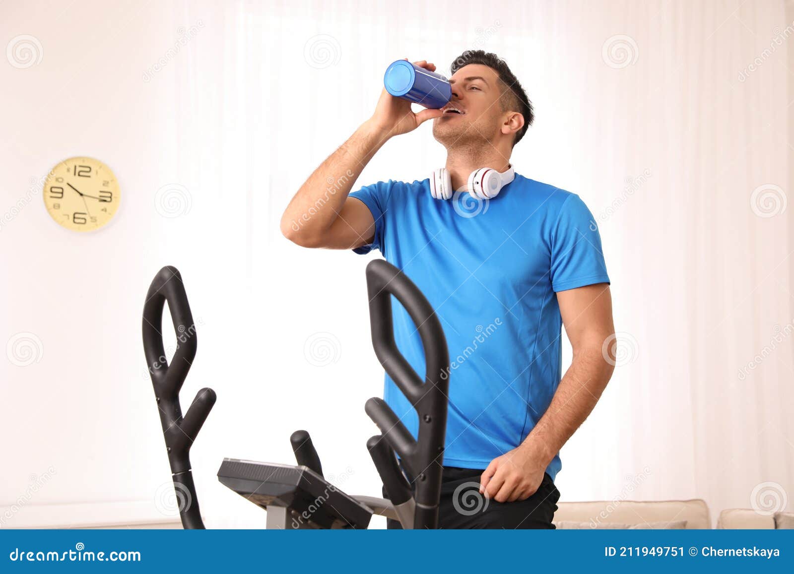 Man Drinking Water on Modern Elliptical Machine at Home Stock Image ...