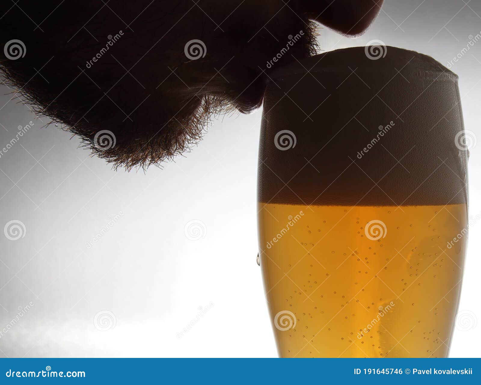 A Man Drinks Beer. Side View of a Handsome Young Man Drinking Beer ...