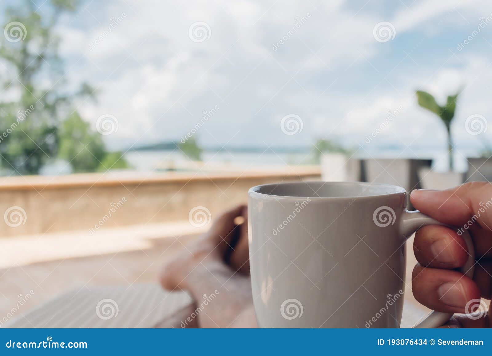 Man Drinks Coffee on the Balcony by the Sea in Concept of Vacation ...