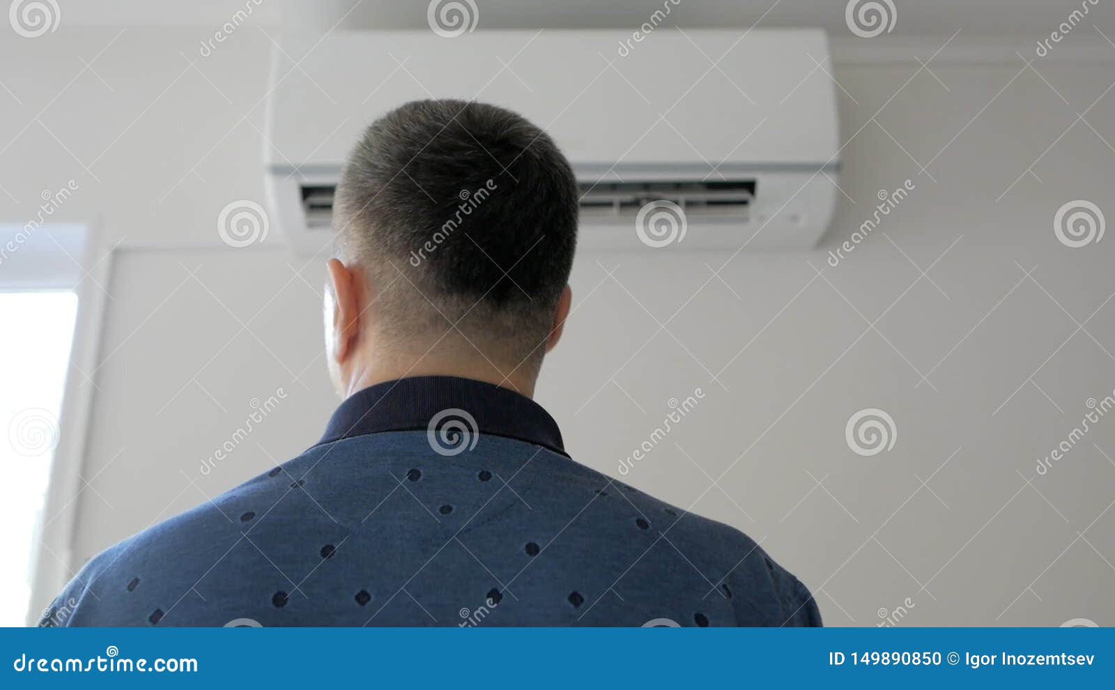 A Man Dripping with Sweat Cools Under a Stream of Cold Air Standing ...