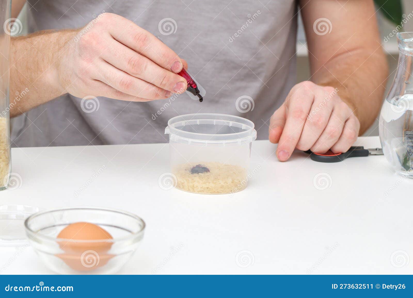 A Man Drips Red Dye into a Container of Rice. an Unusual Way of ...