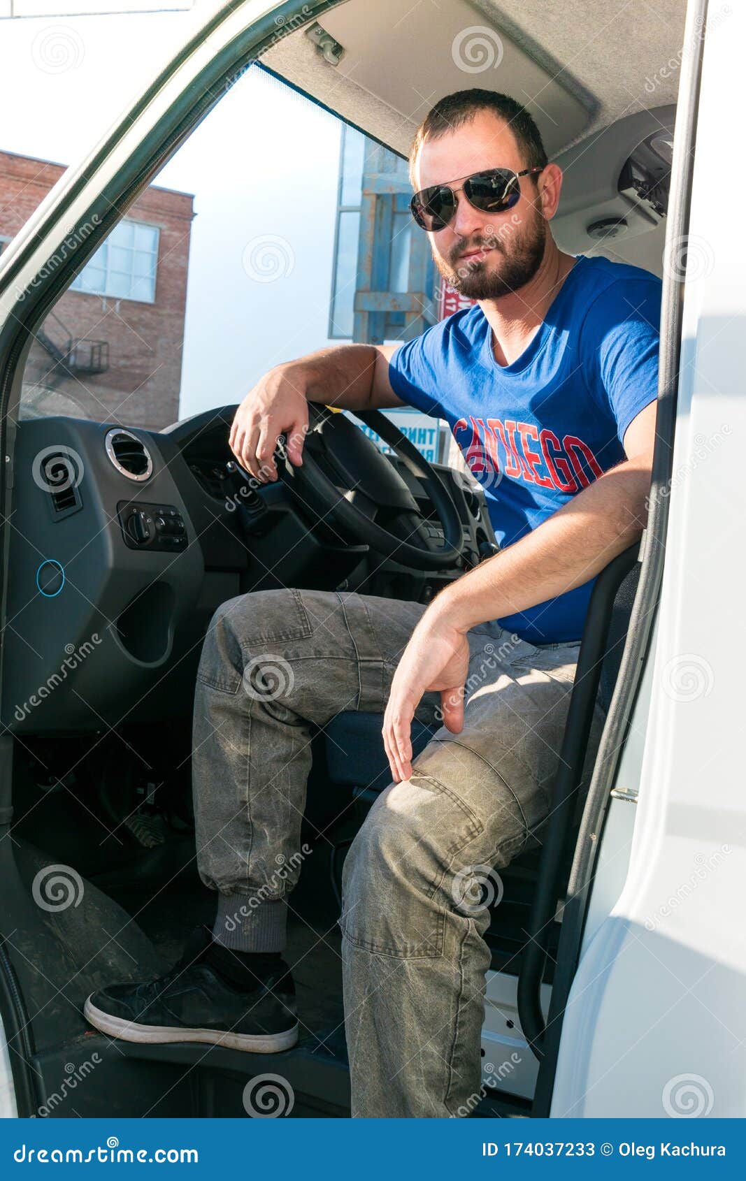 A Man Driver is Sitting in the Cab of a Modern Truck. Stock Image ...