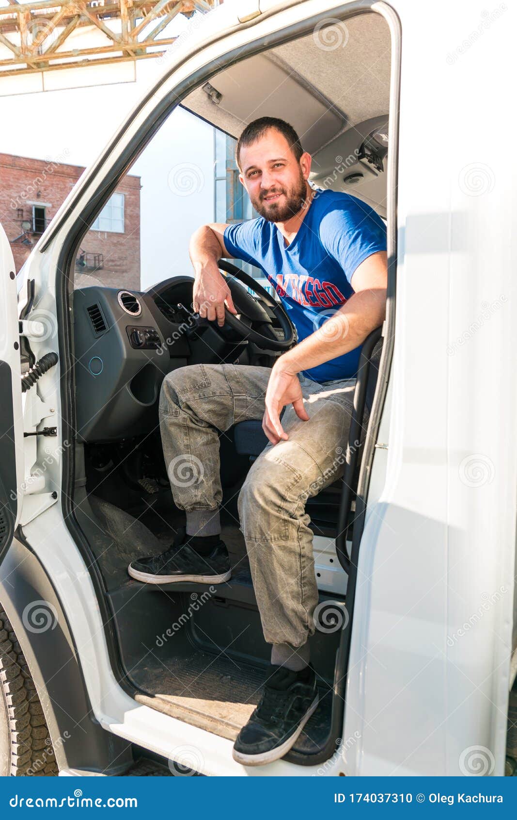 A Man Driver is Sitting in the Cab of a Modern Truck. Stock Photo ...