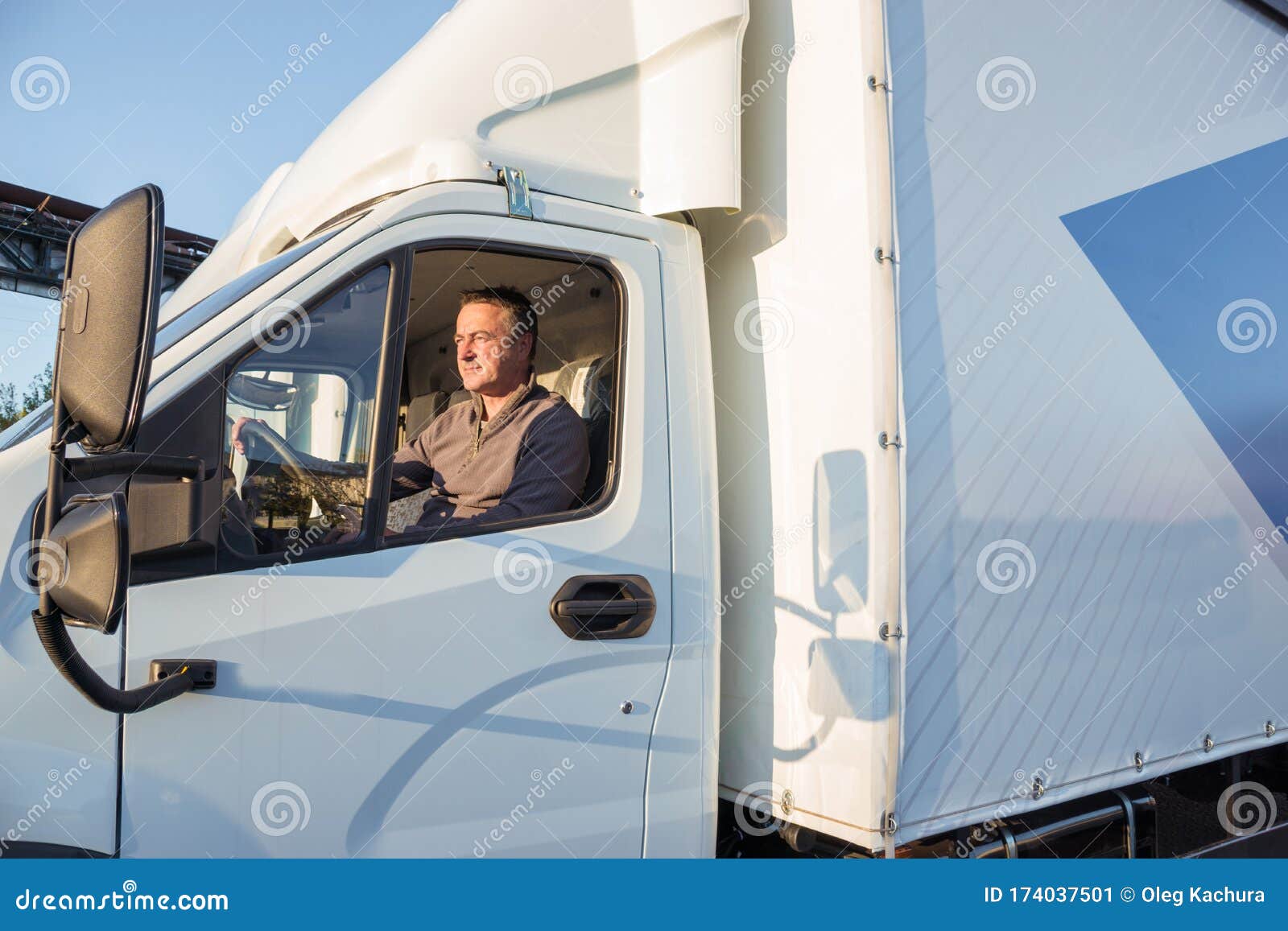 A Man Driver is Sitting in the Cab of a Modern Truck Stock Image ...