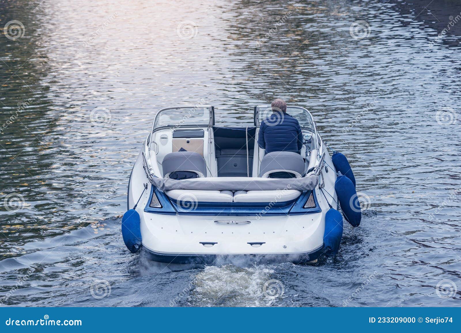 Man drives a boat stock photo. Image of fashionable - 233209000