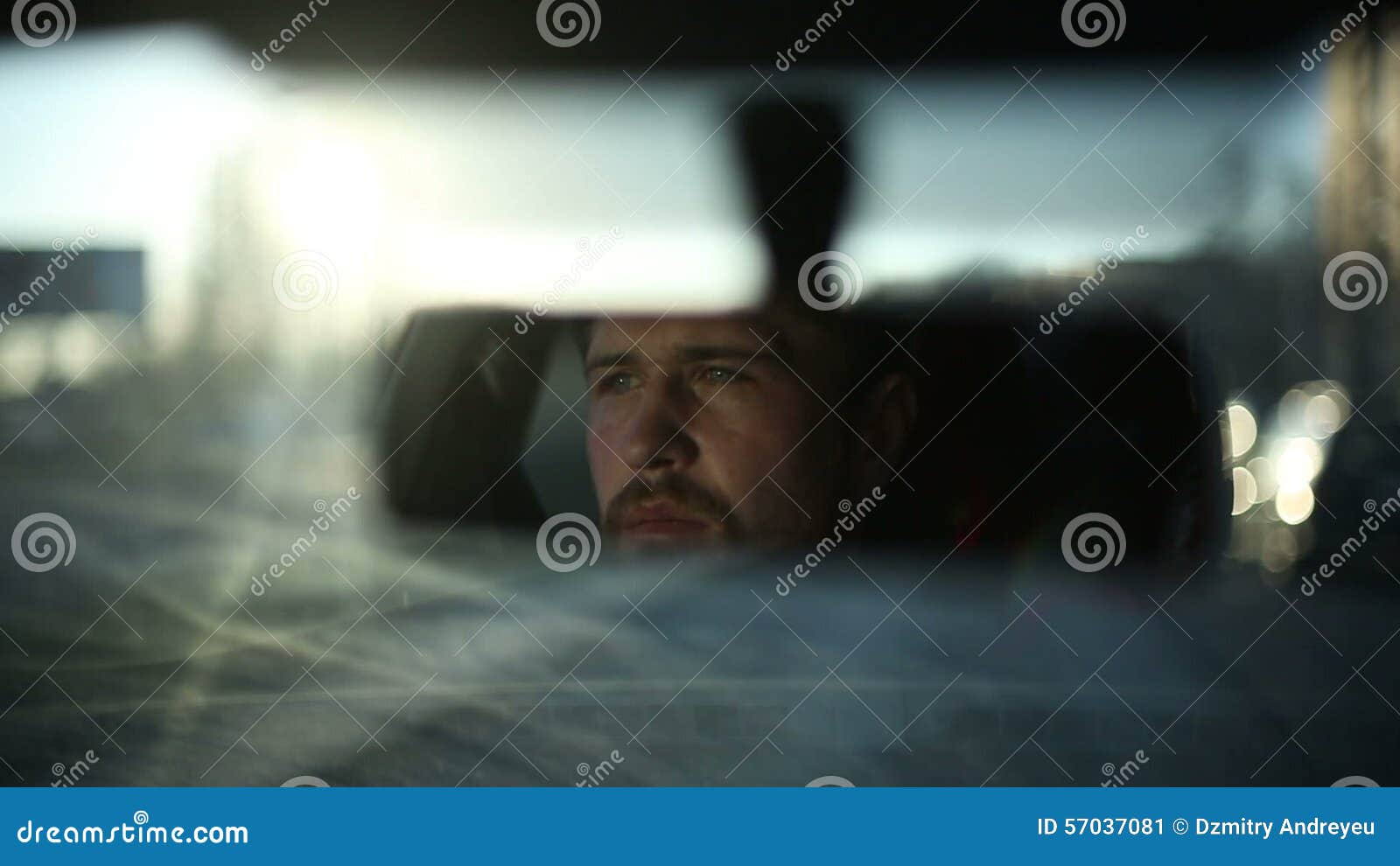 A Man Drives a Car. Reflection Face in the Rearview Mirror of the Car ...