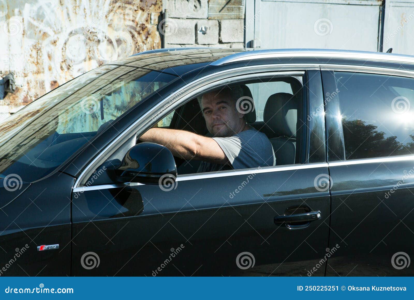 A Man Driving an Audi Q3 Car in Black. Subcompact Luxury Crossover Audi ...