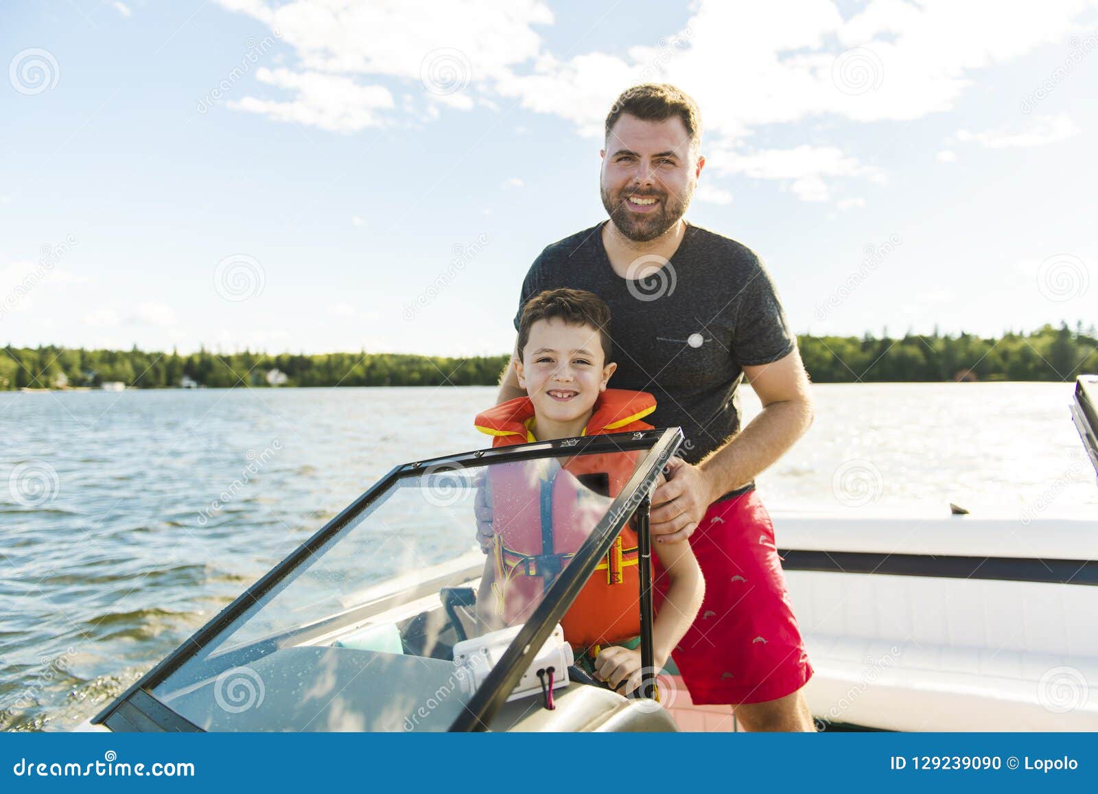 Man Driving Boat on Holiday with His Son Kid Stock Photo - Image of ...