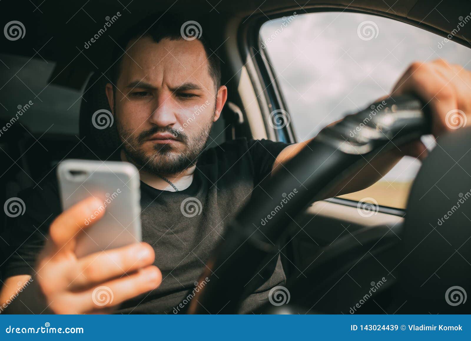 A Man Driving a Car Distracted by a Smartphone Stock Image - Image of ...