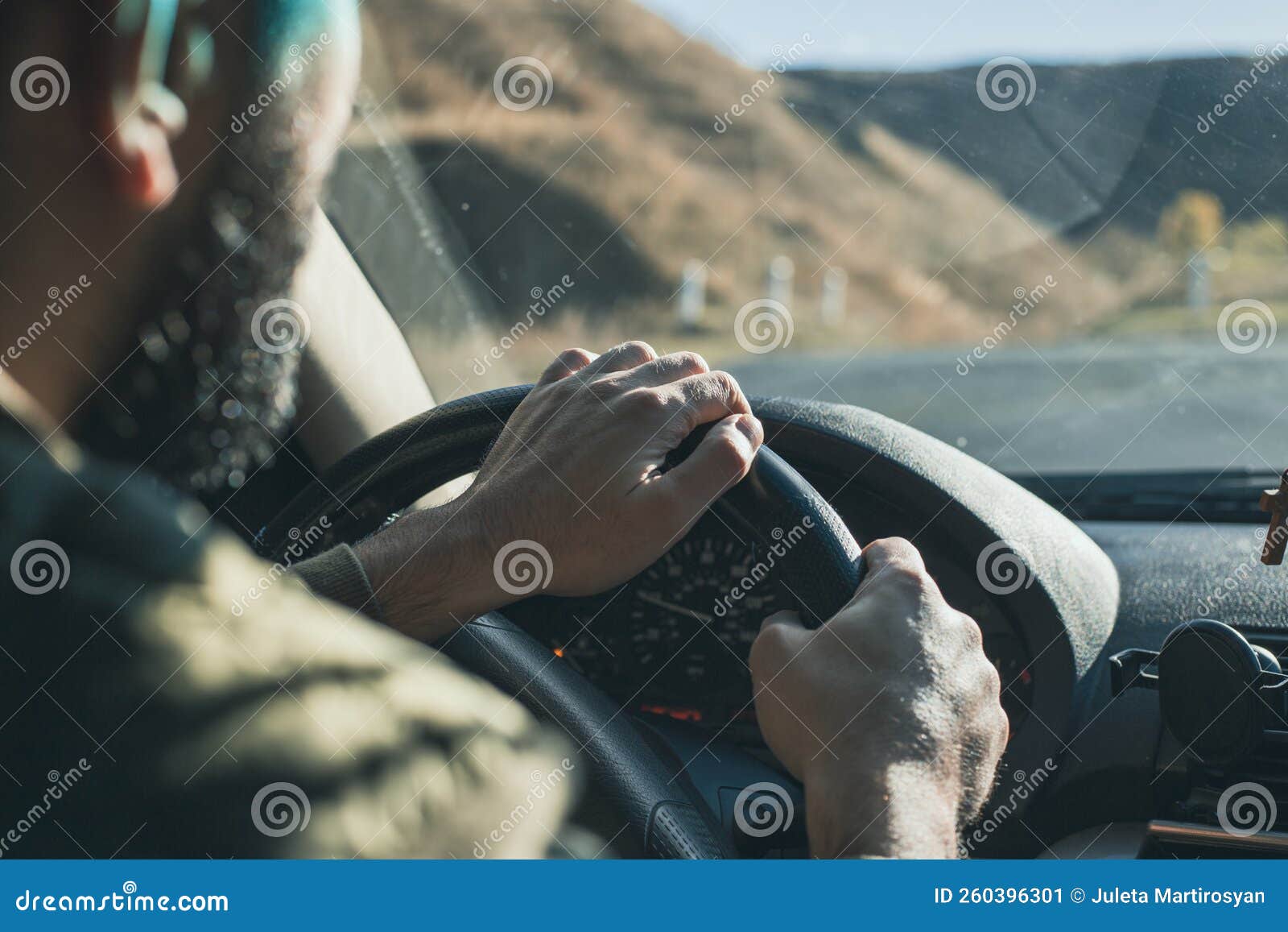 Man driving a car stock image. Image of hand, sunset - 260396301