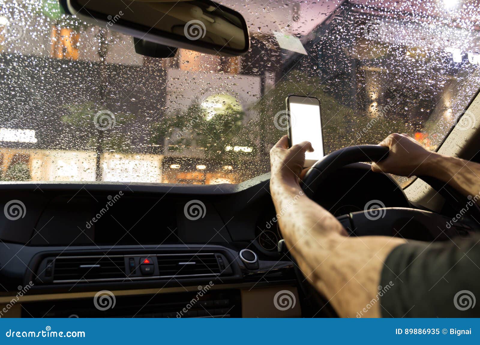 Man Driving Car and Using Cell Phone while Raining at Night Stock Image ...