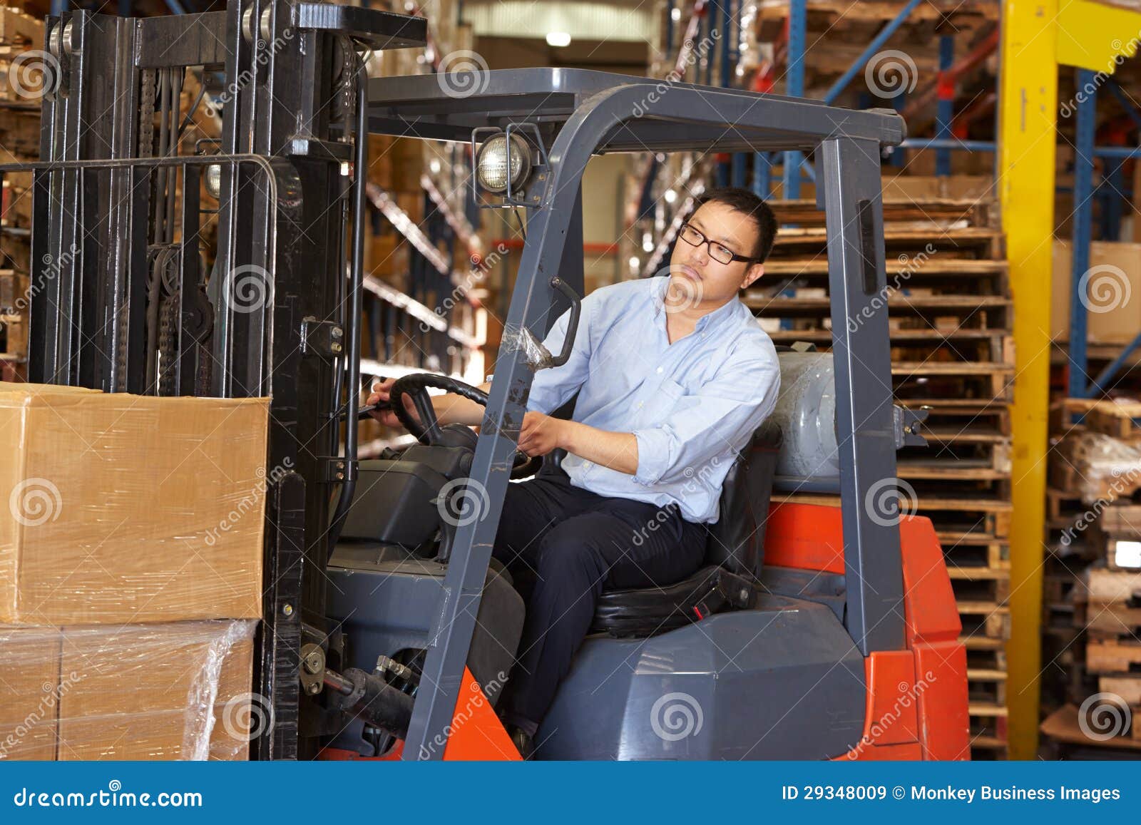 Man Driving Fork Lift Truck in Warehouse Stock Image - Image of ...