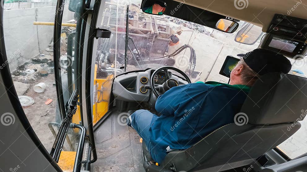 Man Driving a Front Loader Forward and Backward, Inside the Cabin View ...
