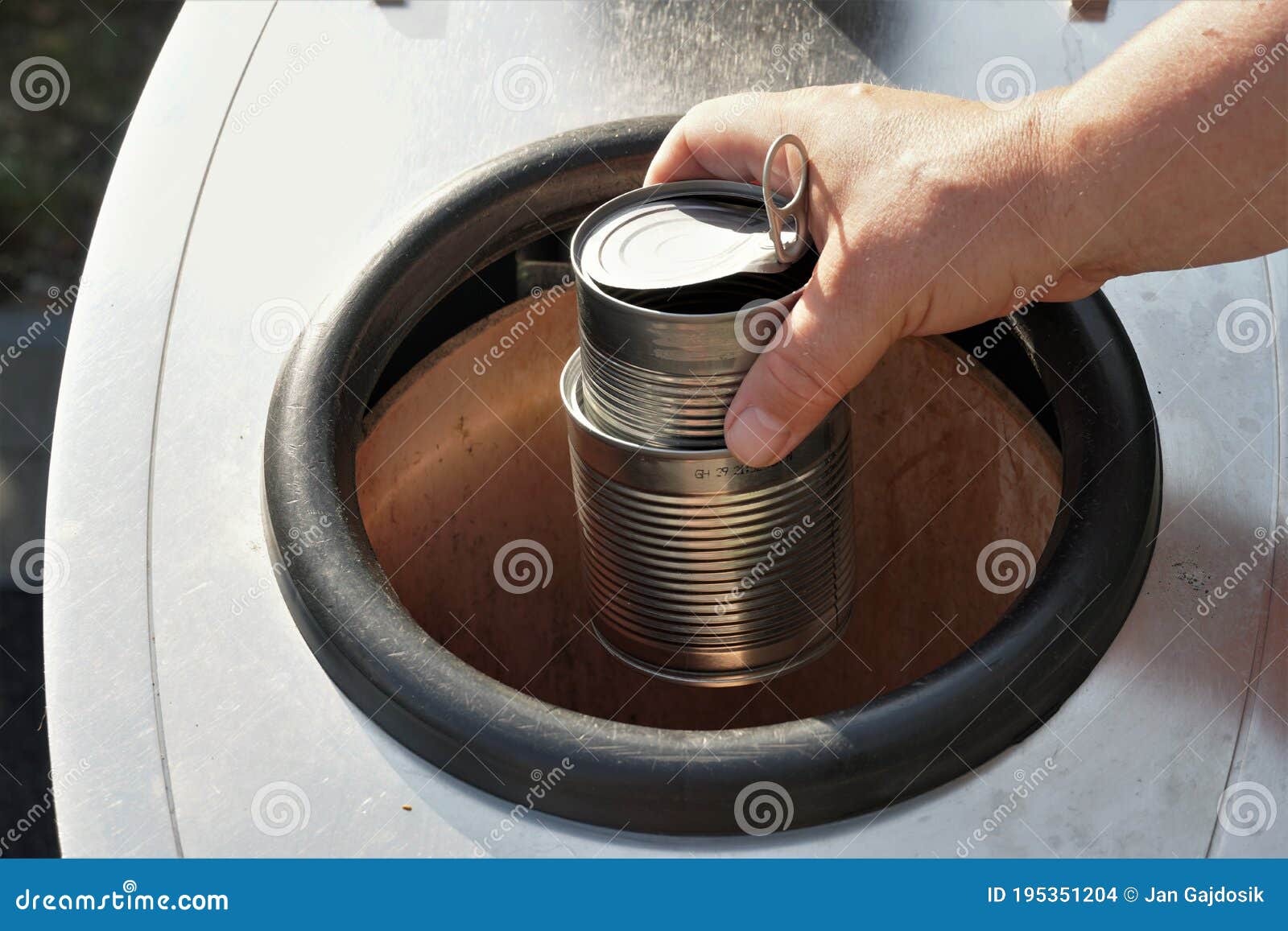 A Man Dropping Empty Cans into Container for Separation of Home Waste ...