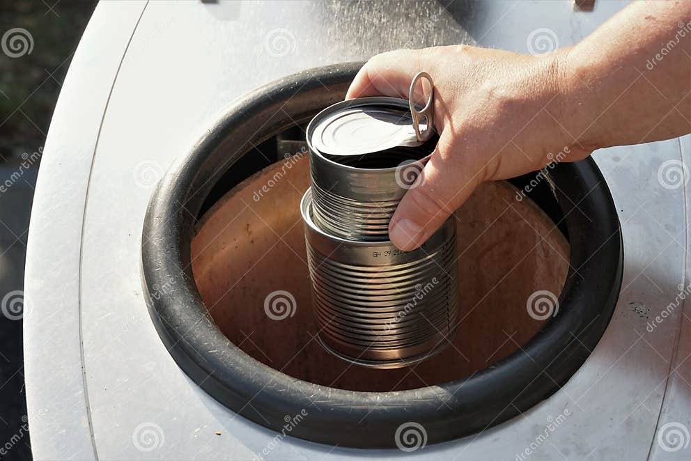 A Man Dropping Empty Cans into Container for Separation of Home Waste ...