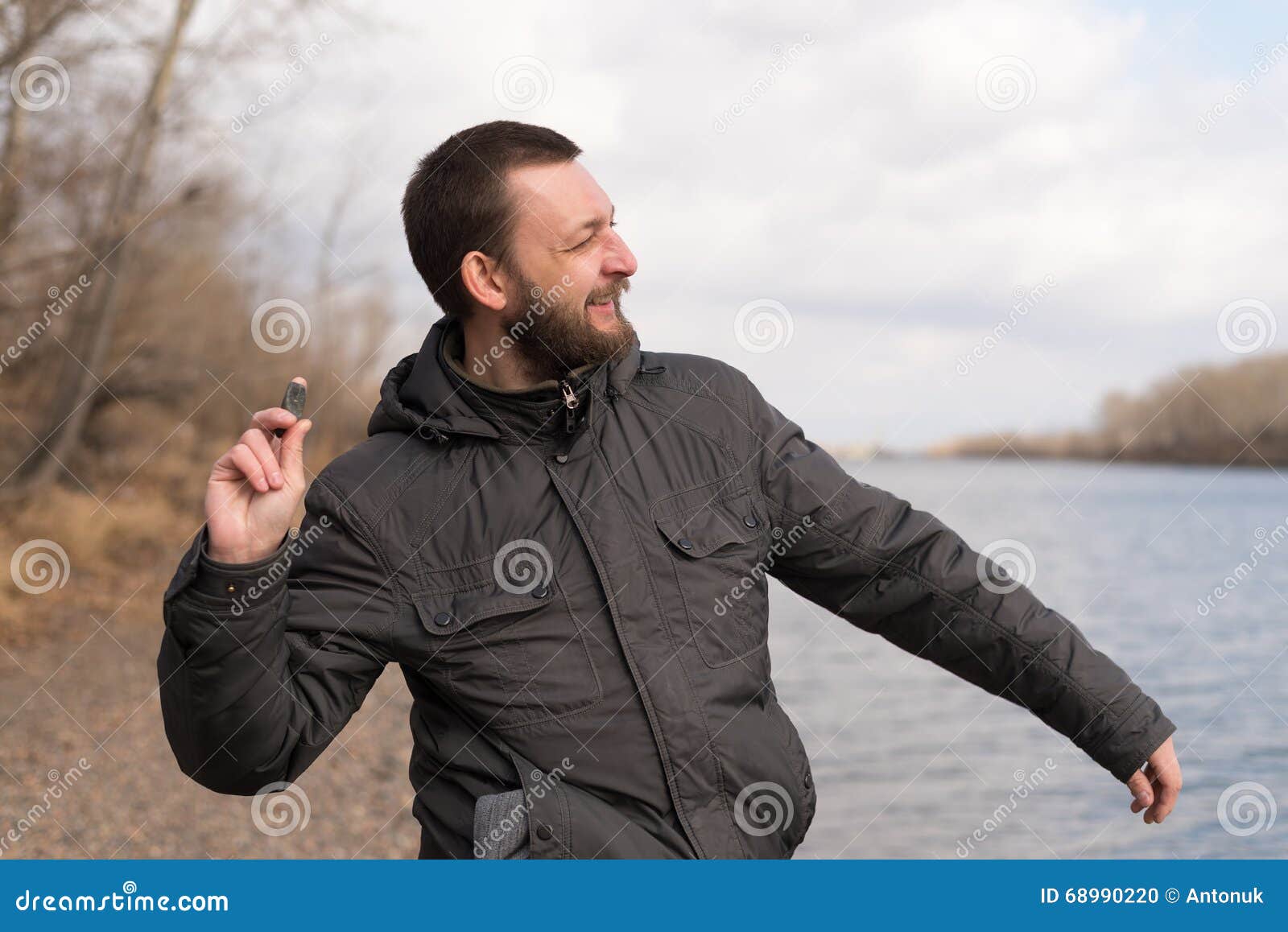 Man Dropping a Stone into the River Stock Photo - Image of gesture ...