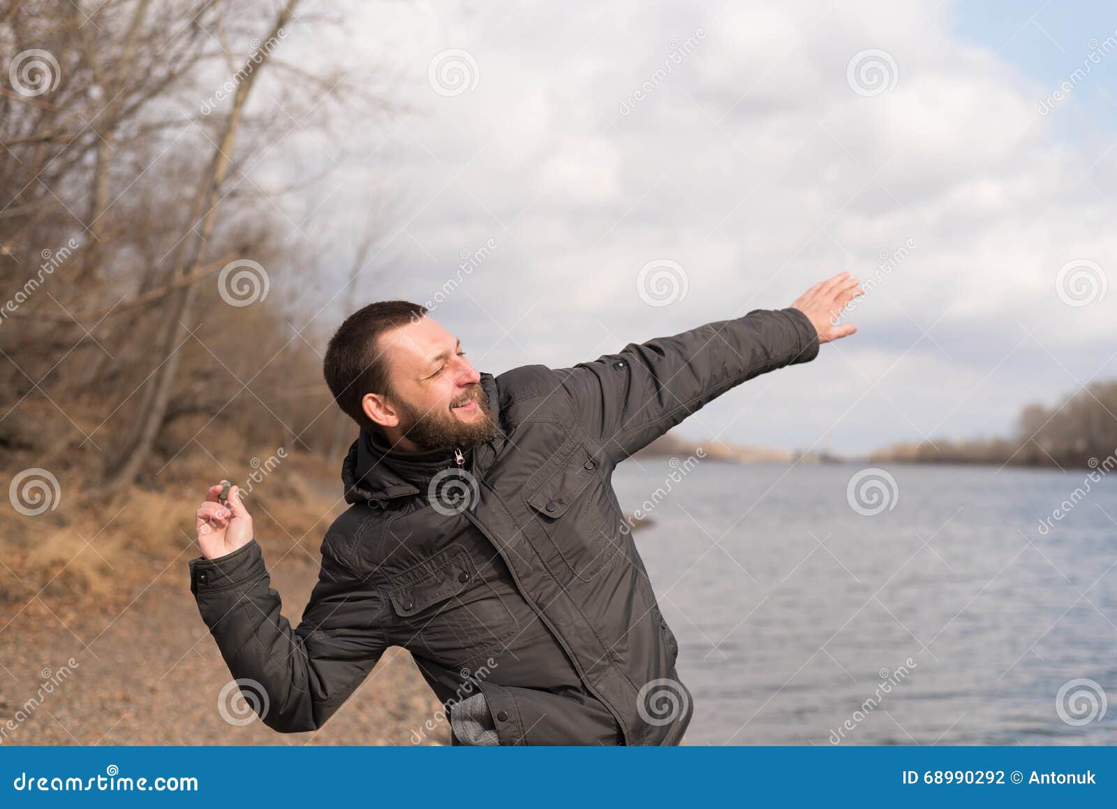 Man Dropping a Stone into the River Stock Photo - Image of hands ...