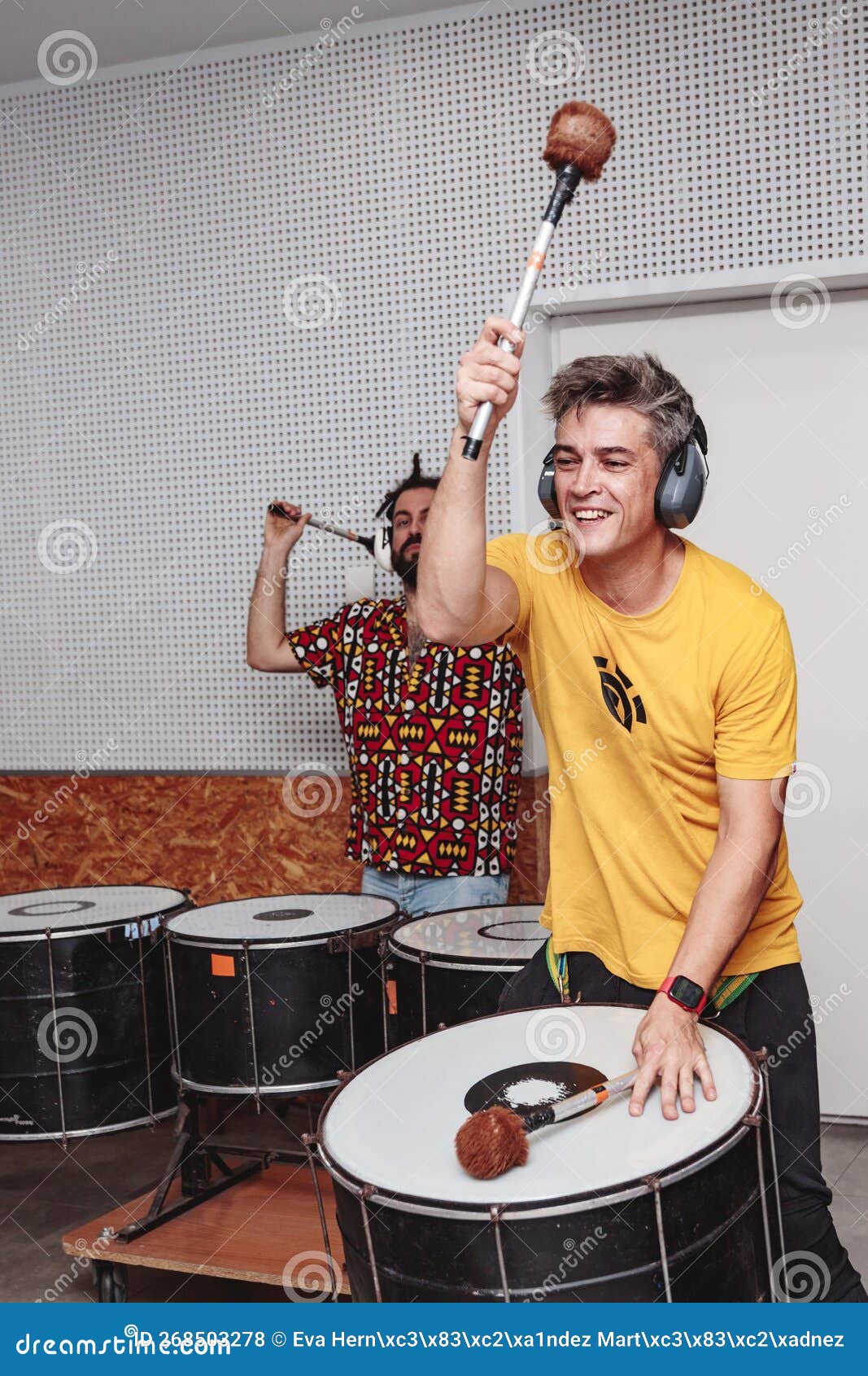 Man Drumming with Maces Inside a Studio Stock Photo - Image of mace ...
