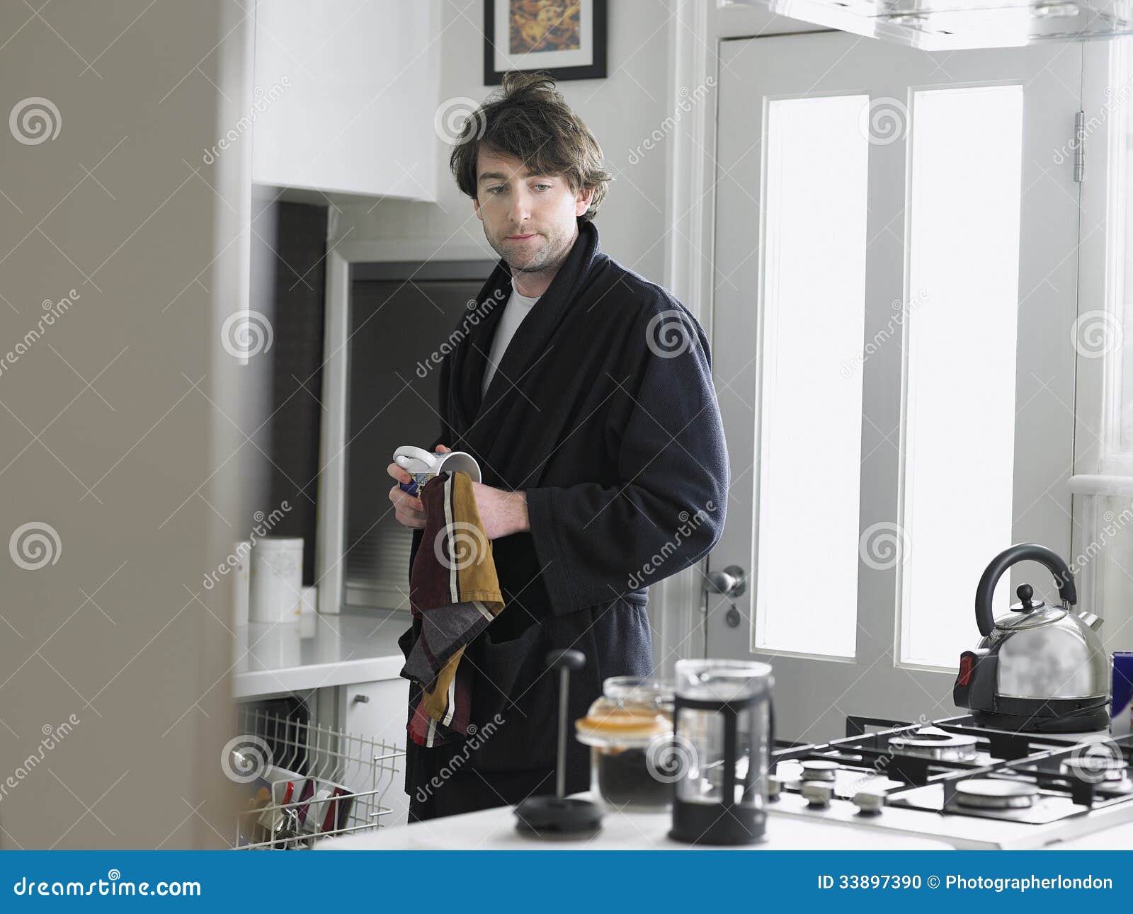 Man Drying Tea Cup with Towel in Kitchen Stock Photo - Image of ...
