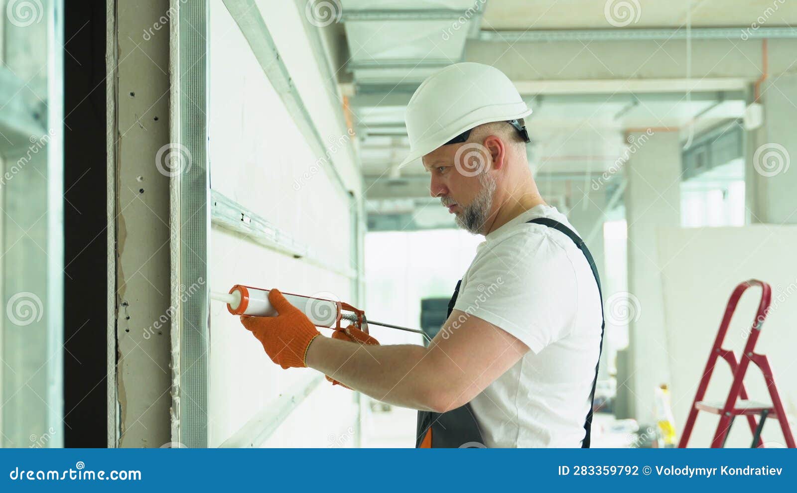 A Man Drywall Worker or Plasterer Sealing Seams of the Office Wall ...