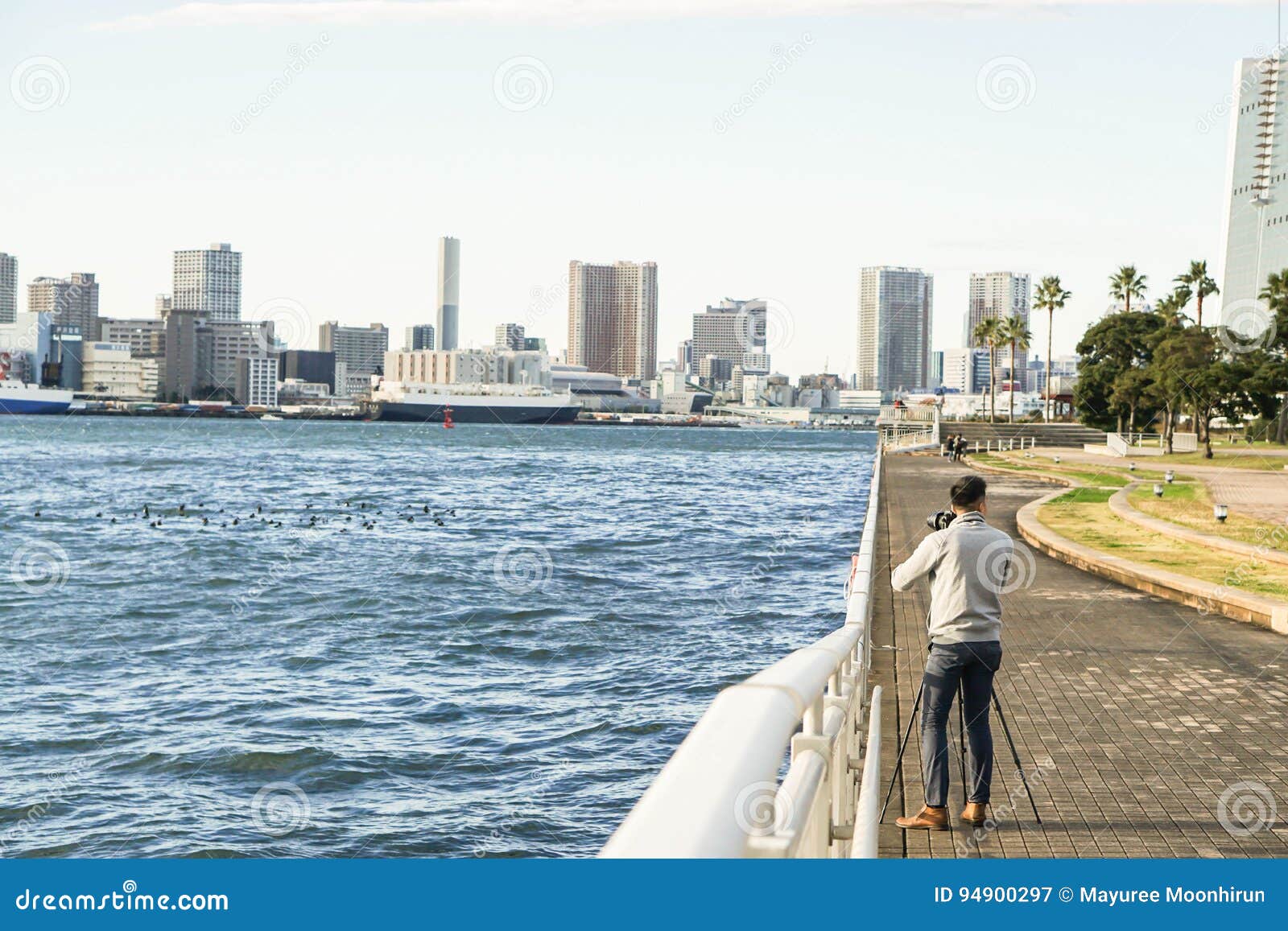 Man with DSLR Camera and Tripod for Taking Photographs at Riverside ...