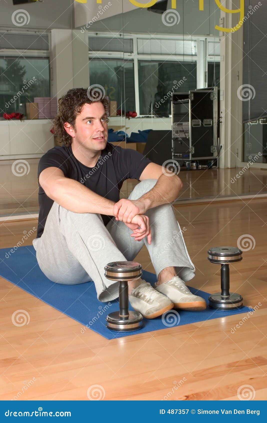 Man with Dumbbels on Exercise Mat Stock Image - Image of lifting ...