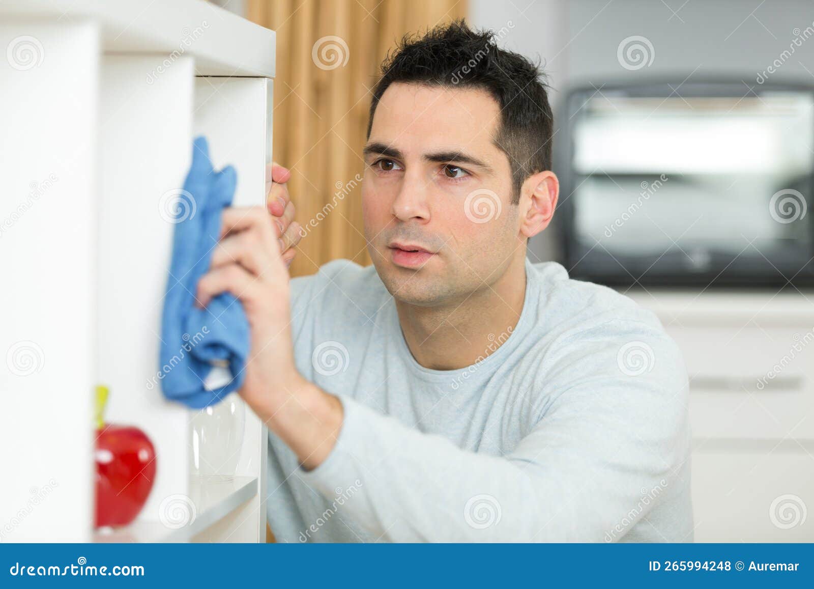 Man dusting at home stock photo. Image of work, bookshelf - 265994248