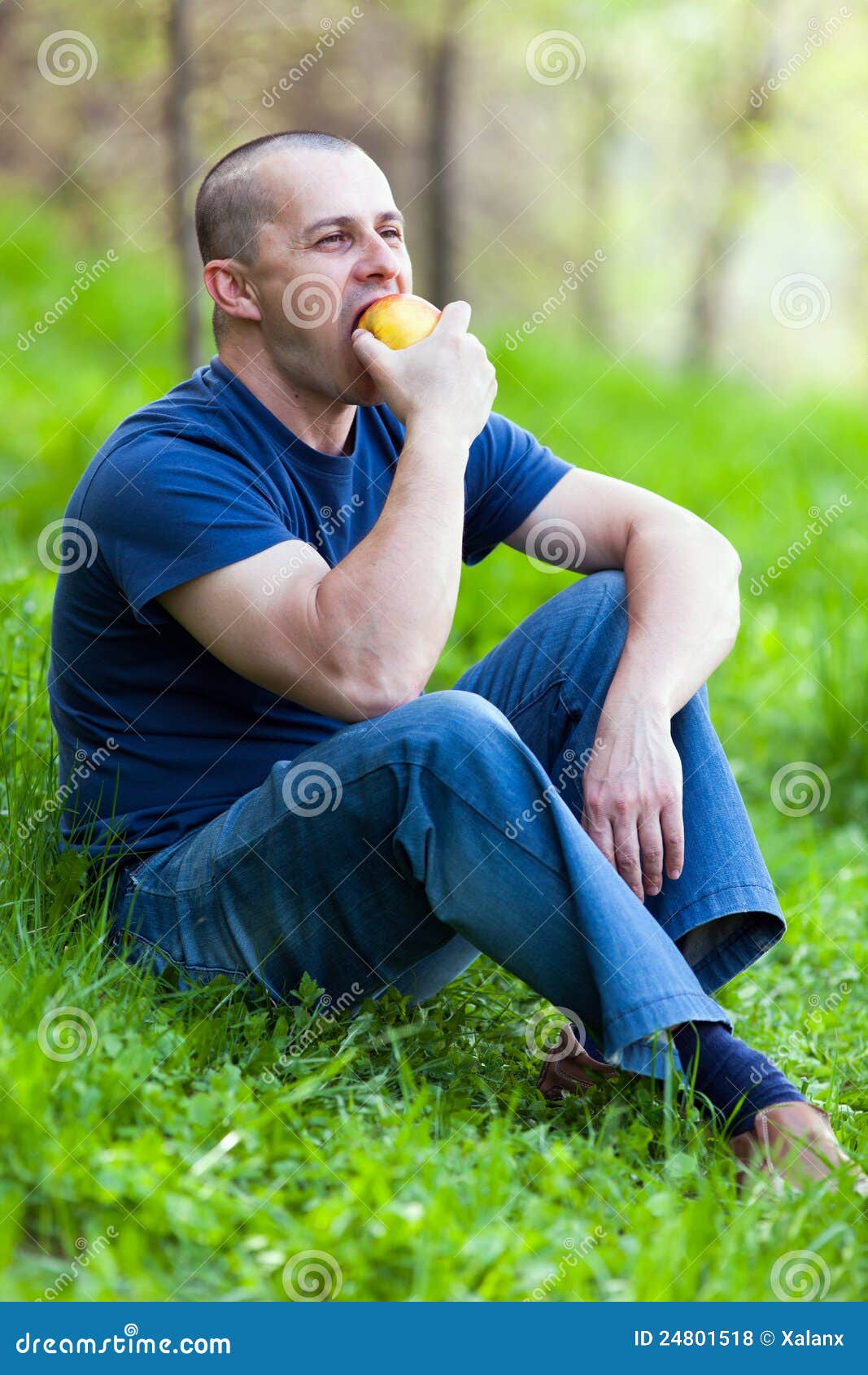Man Eating an Apple Outdoor Stock Photo - Image of green, field: 24801518
