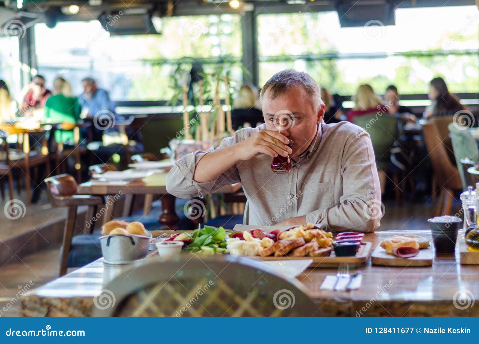 The Man is Eating Breakfast in the Restaurant. Stock Image - Image of ...