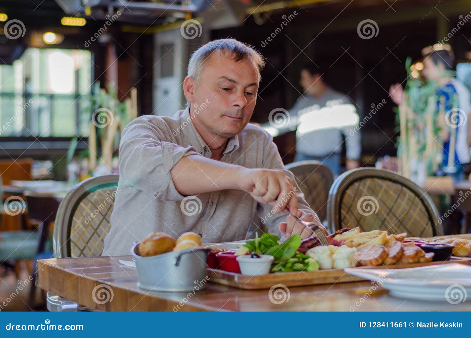 The Man is Eating Breakfast in the Restaurant. Stock Image - Image of ...