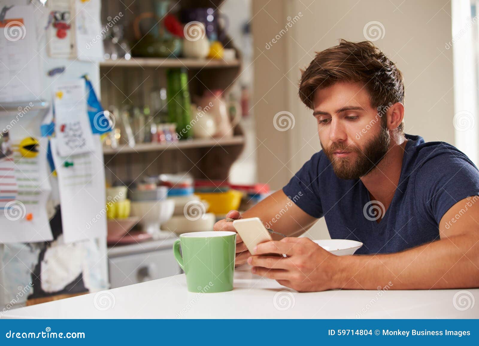 Man Eating Breakfast Whilst Using Mobile Phone Stock Photo - Image of ...