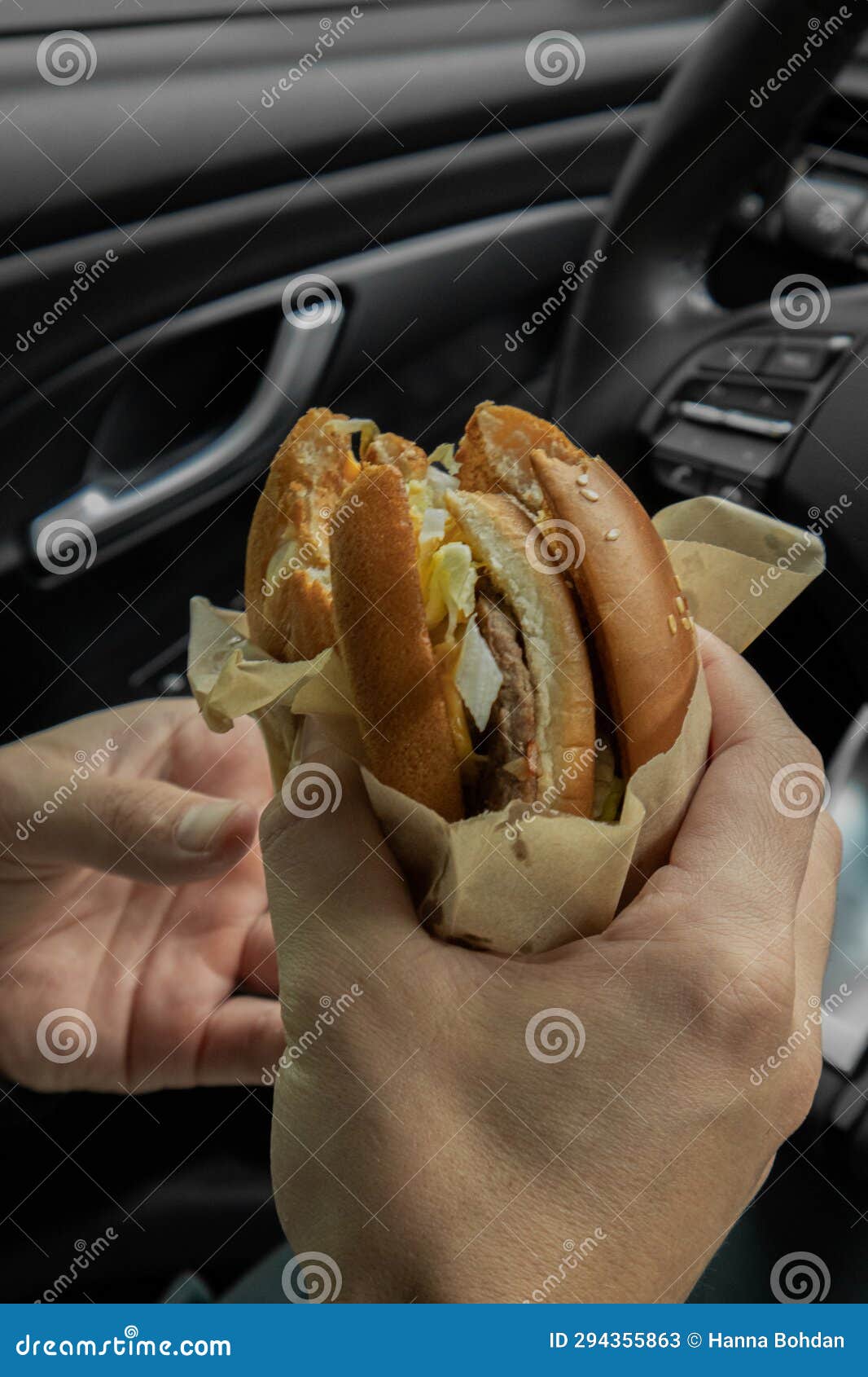 The man is eating a burger stock image. Image of driving - 294355863