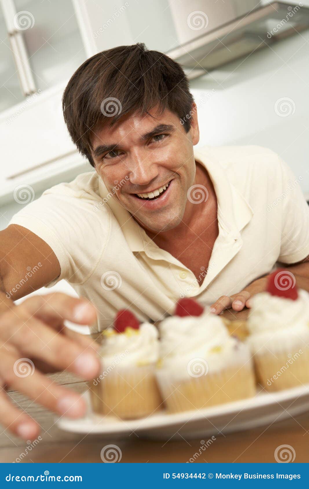 Man Eating Cakes in Kitchen Stock Photo - Image of cupcake, eating ...
