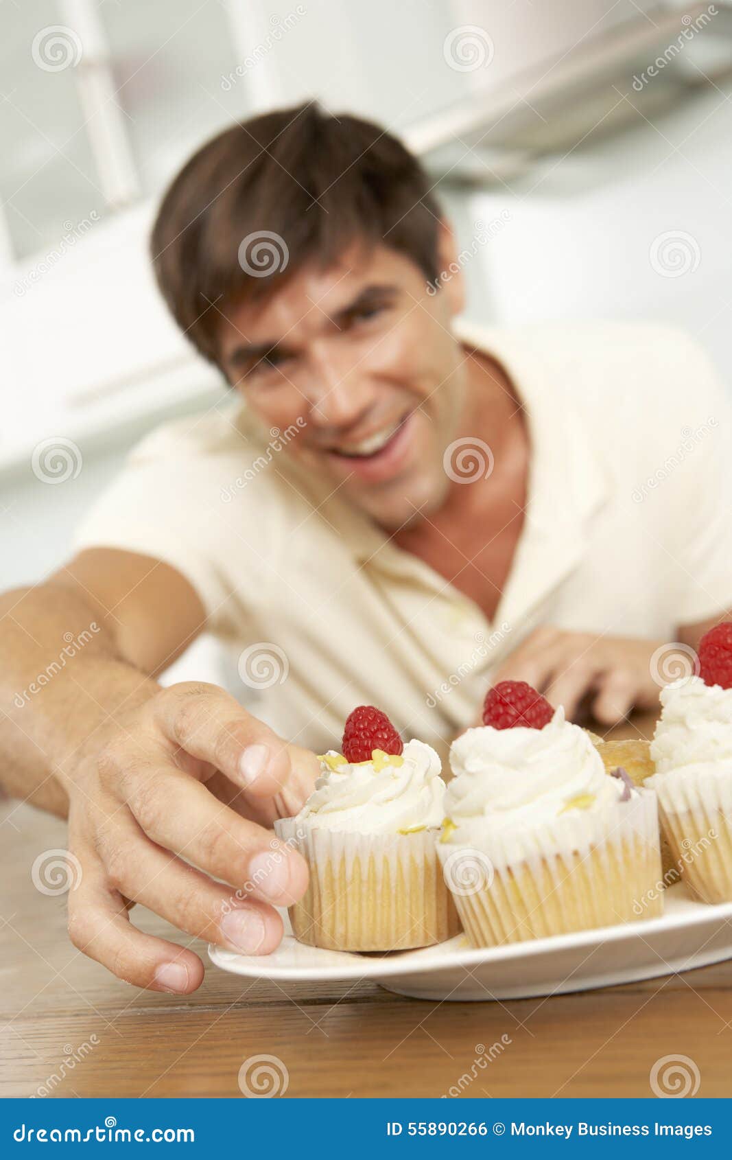 Man Eating Cakes in Kitchen Stock Photo - Image of adult, cupcake: 55890266