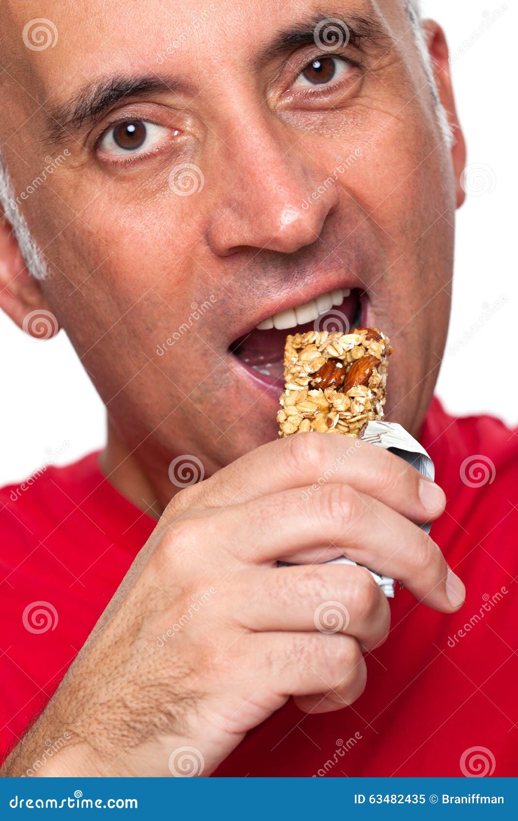 Man eating a cereal bar stock image. Image of adult, healthy - 63482435