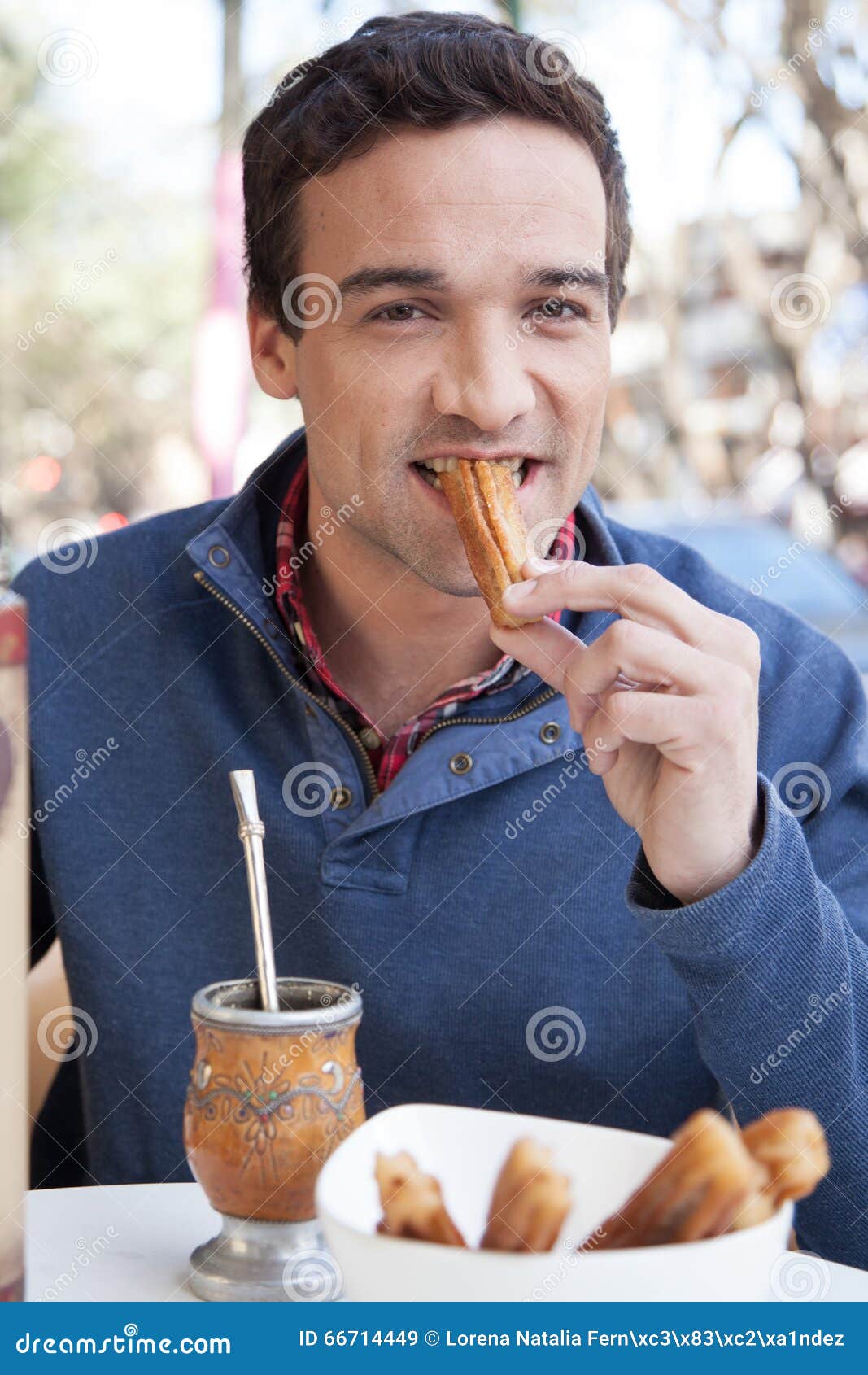 Man eating churro stock image. Image of modern, life - 66714449
