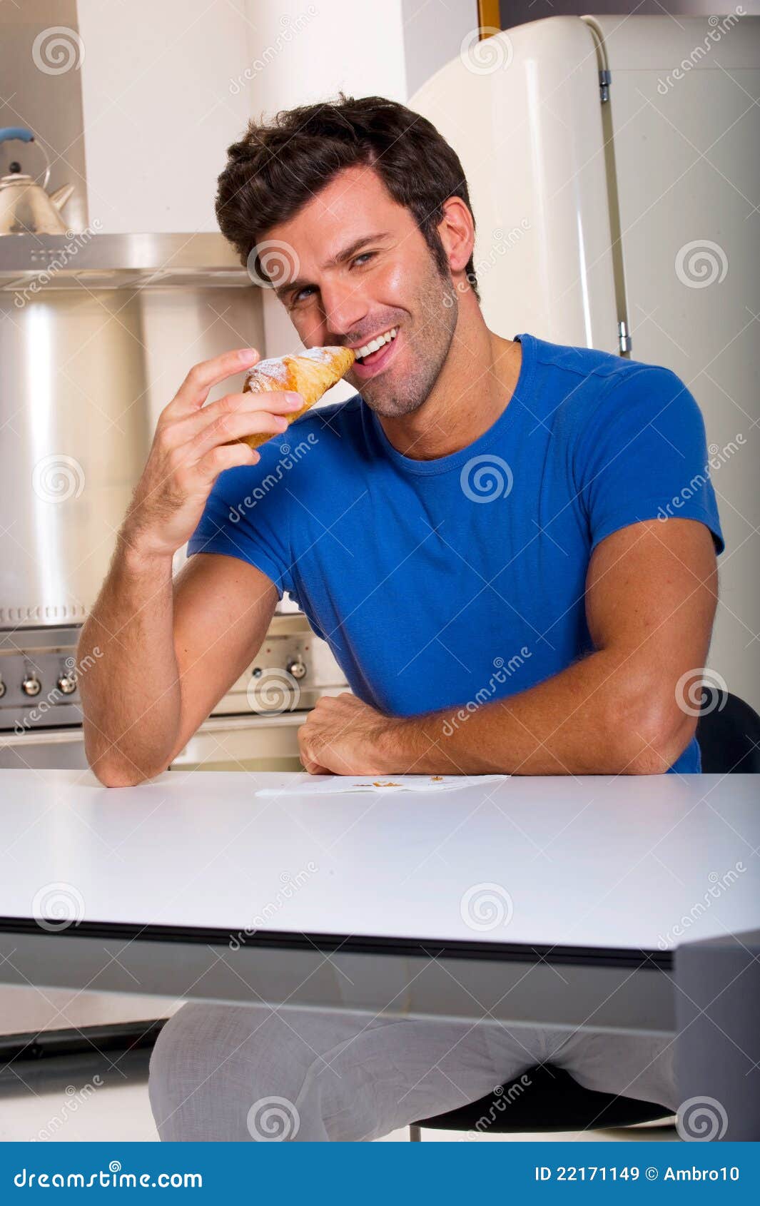 Man eating a croissants stock image. Image of drink, person - 22171149