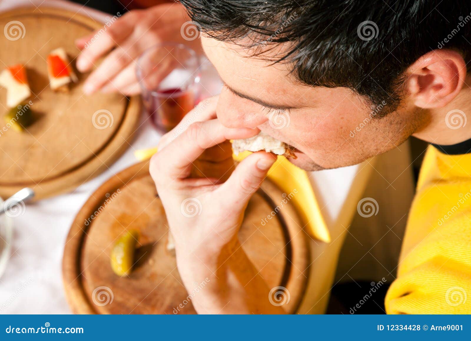 Man eating dinner stock photo. Image of cheese, eating - 12334428