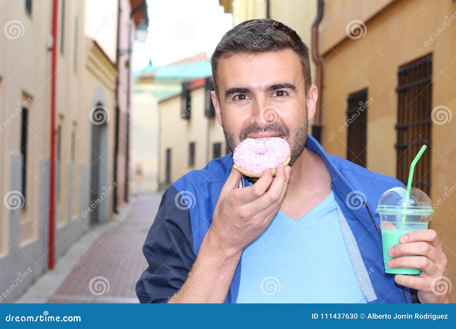 Man Eating Donuts and Drinking a Shake Outdoors Stock Photo - Image of ...