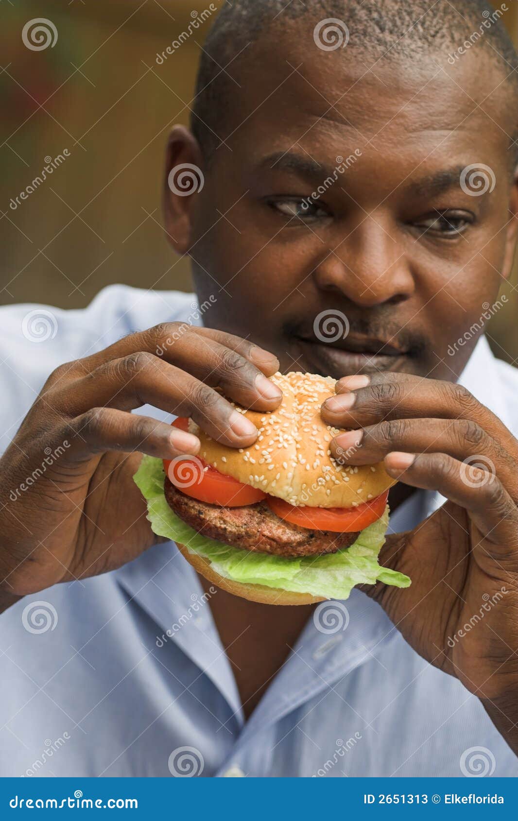 Man eating hamburger stock image. Image of burger, outside - 2651313