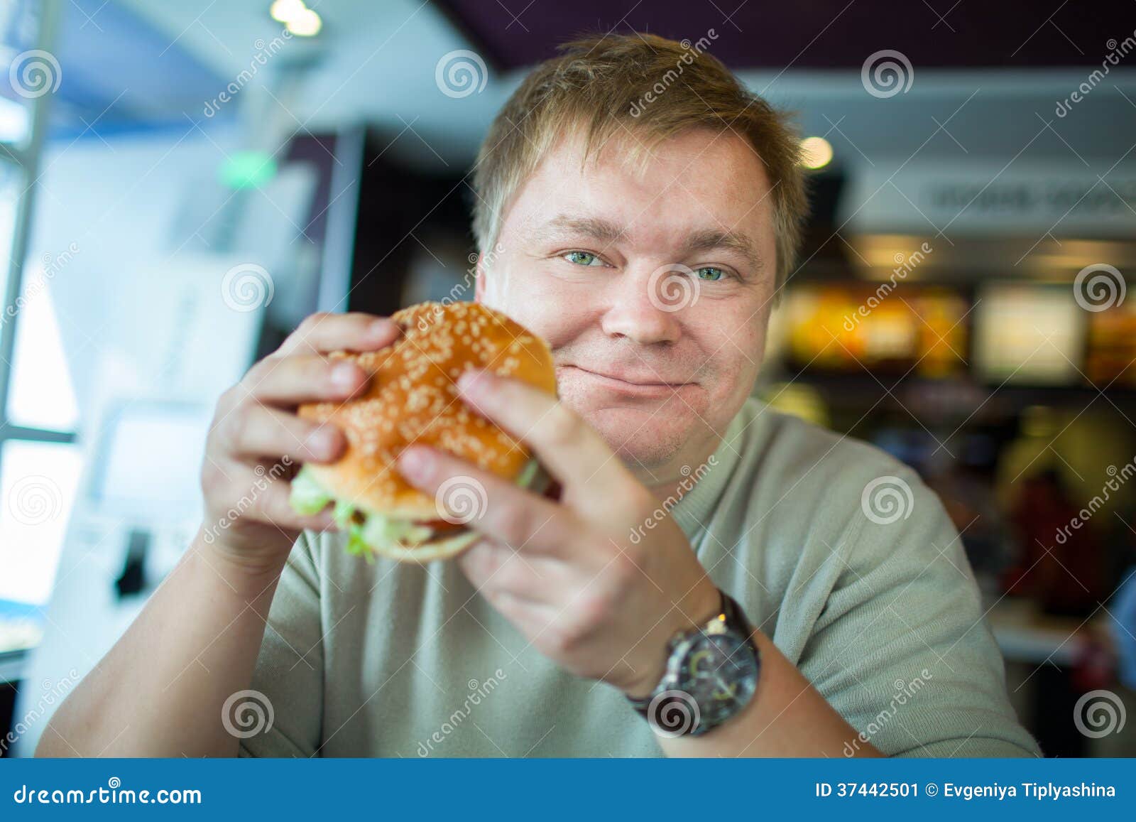 Man eating a hamburger stock image. Image of happy, eatery - 37442501